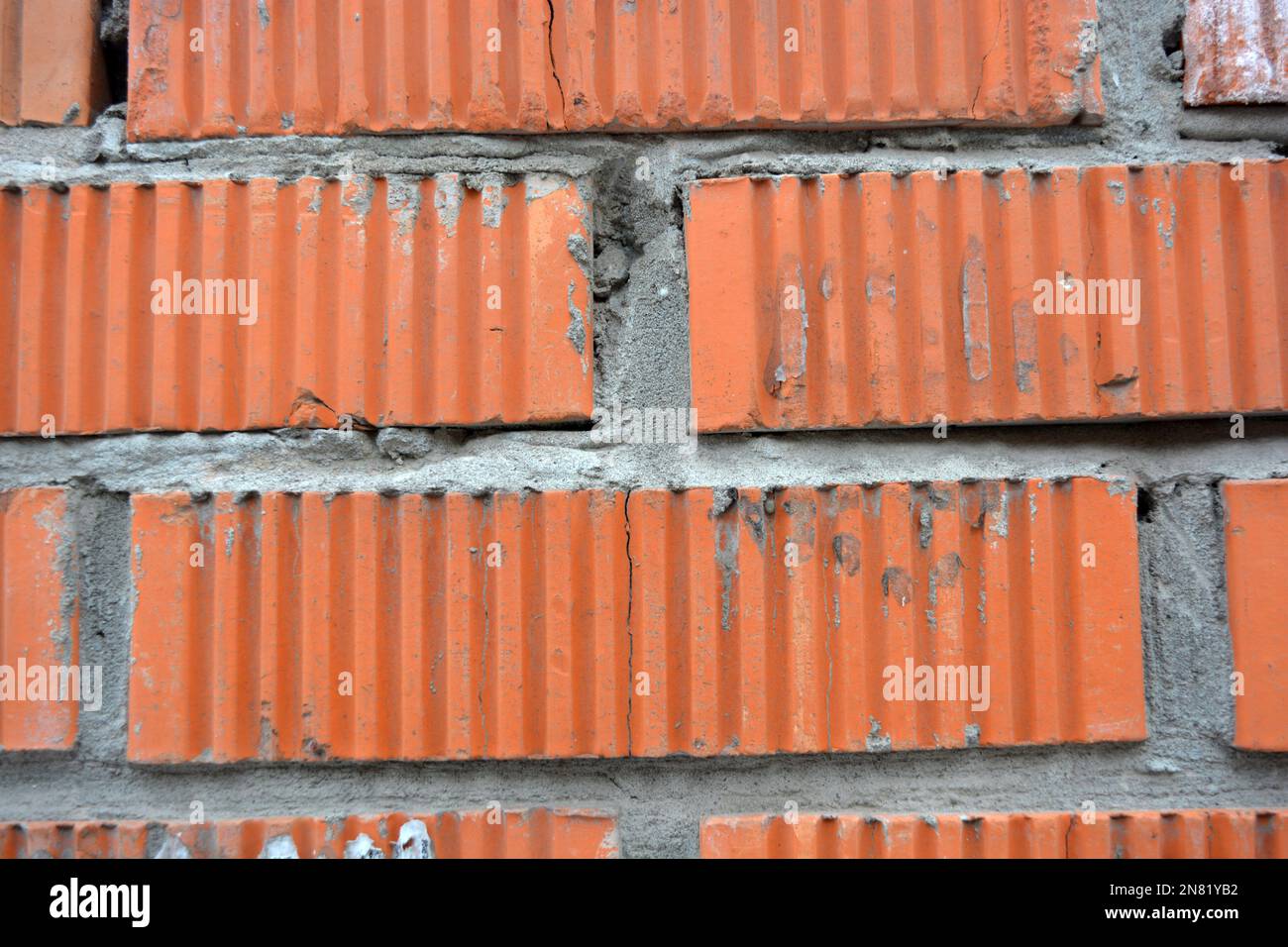 Building background, red beautiful brick wall with grooved sides ...