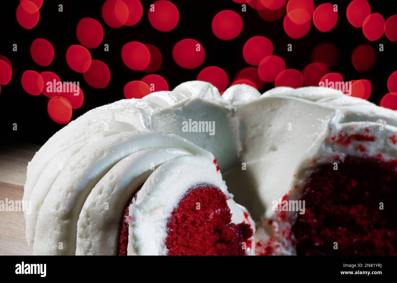 Party lights that are behind a red velvet cake Stock Photo - Alamy