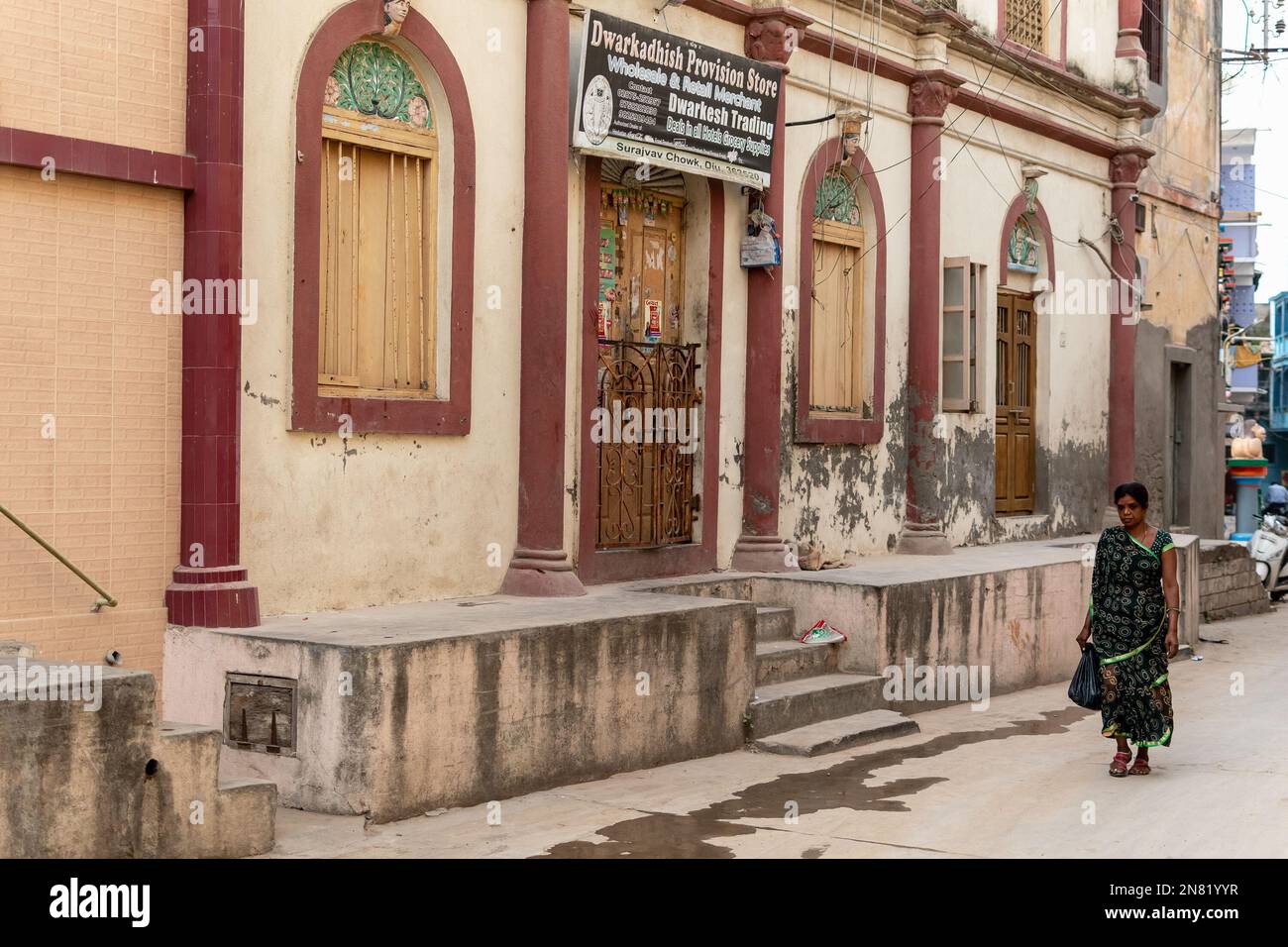 Diu, India - December 2018: An Indian woman walking past an old ...