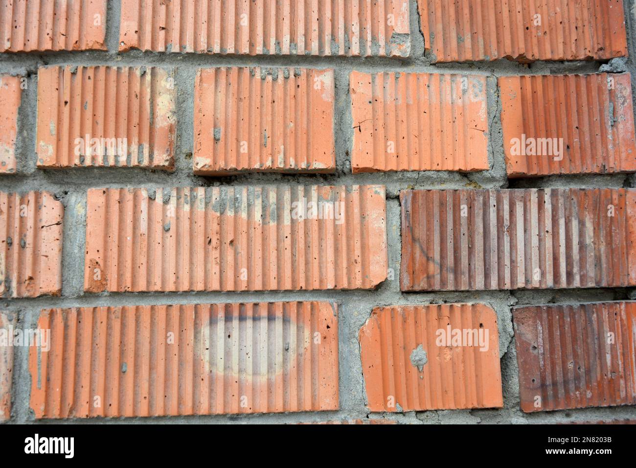 Building background, red beautiful brick wall with grooved sides ...
