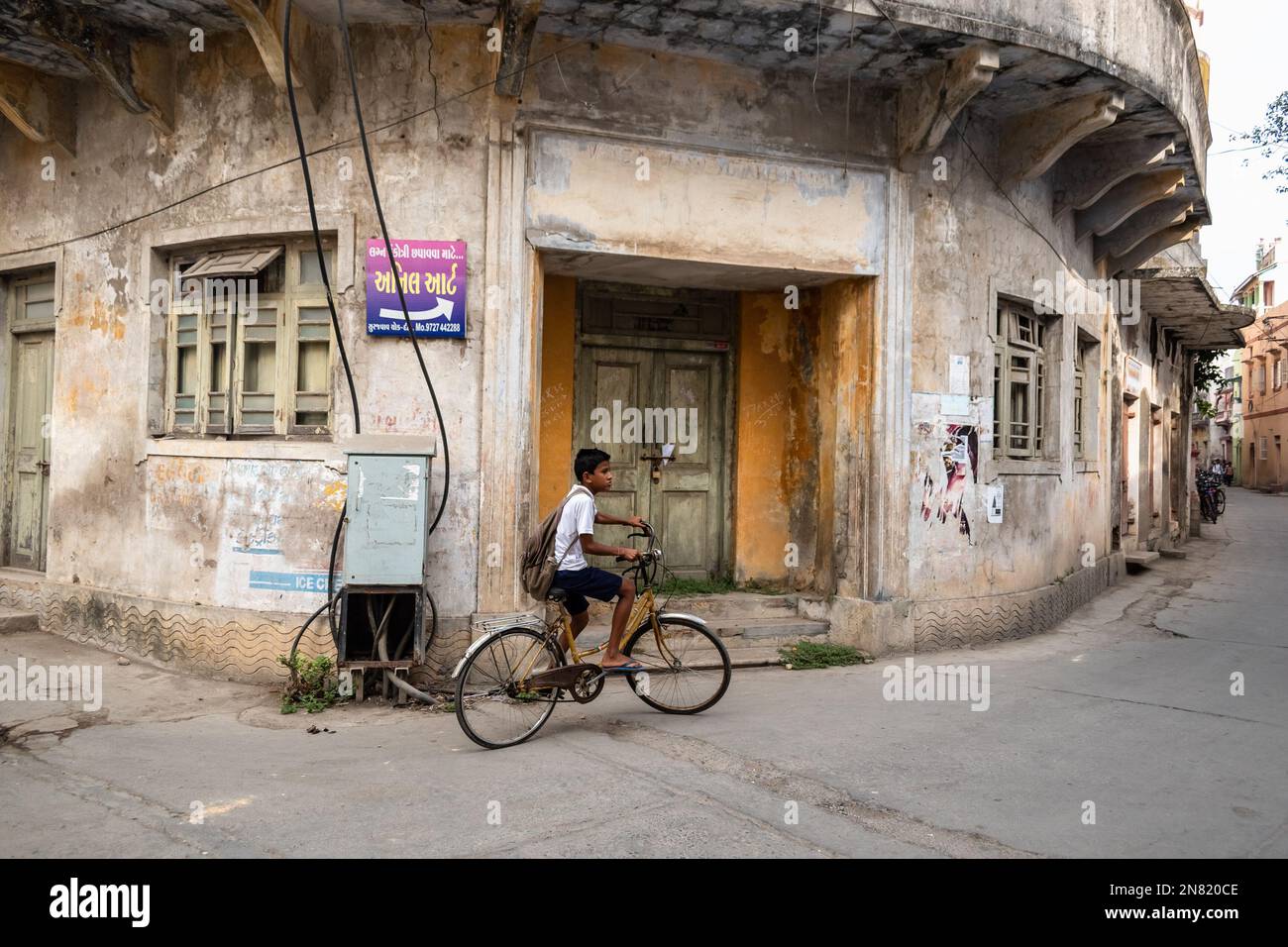 Diu, India - December 2018: An Indian boy riding a bicycle on a street ...