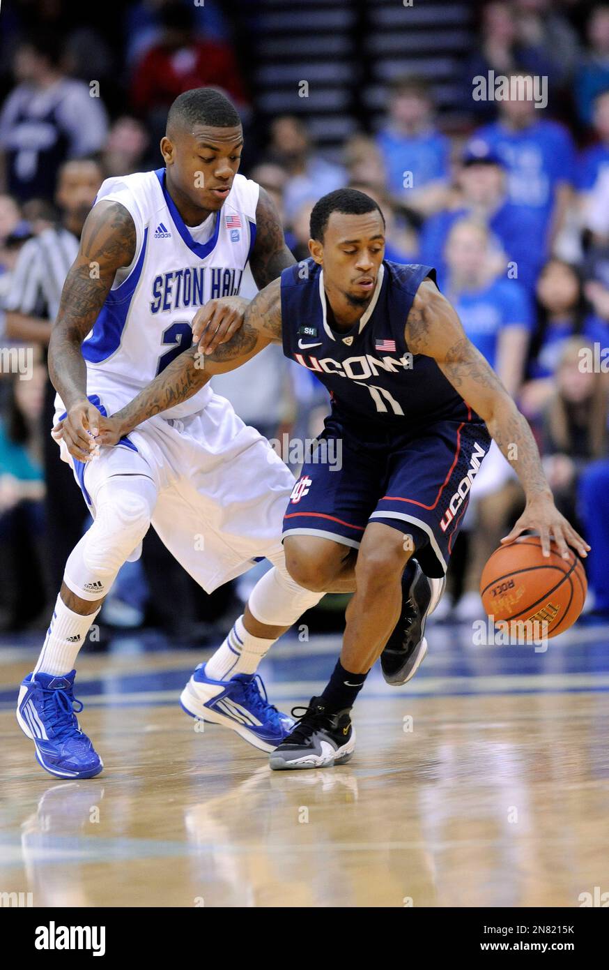 Connecticut's Ryan Boatright, right, dribbles the ball as he is guarded ...