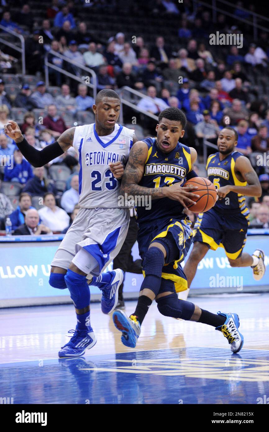 Marquette's Vander Blue, right, drives to the basket as he is guarded ...