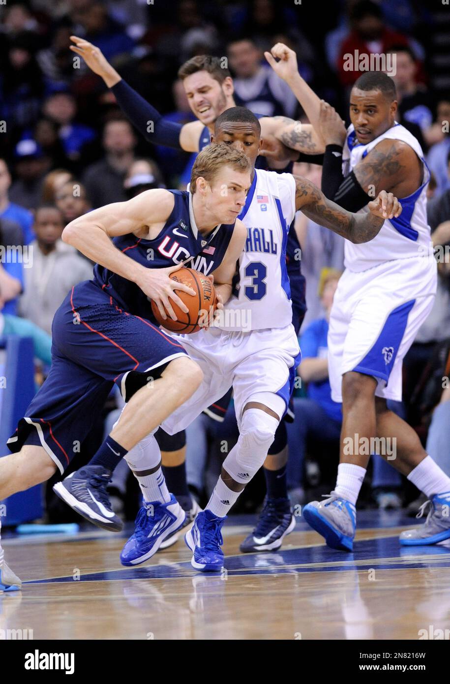 Connecticut's Niels Giffey, left, drives to the basket past Seton Hall ...