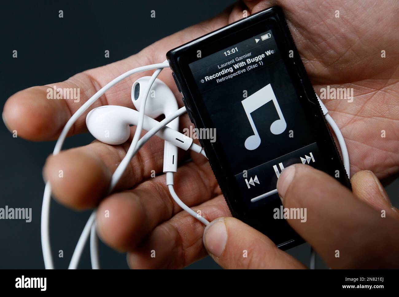 A photo illustration shows a digital music player held in London ...