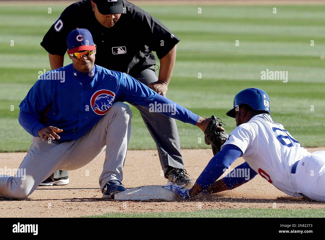 Los Angeles Dodgers' Jeremy Moore, right, slides safely under the tag ...