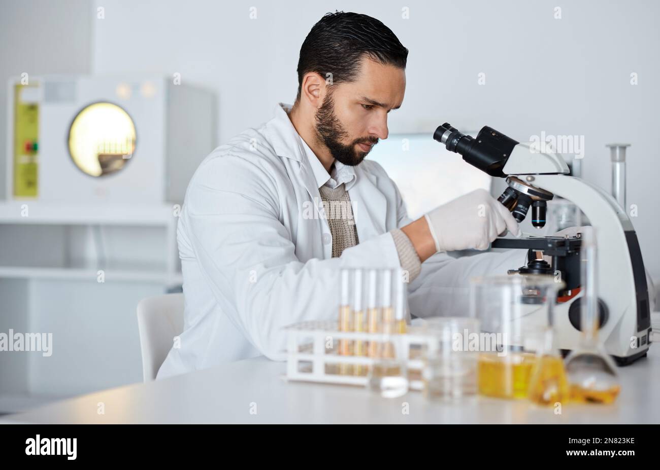 Science, microscope and laboratory with a doctor man at work for ...