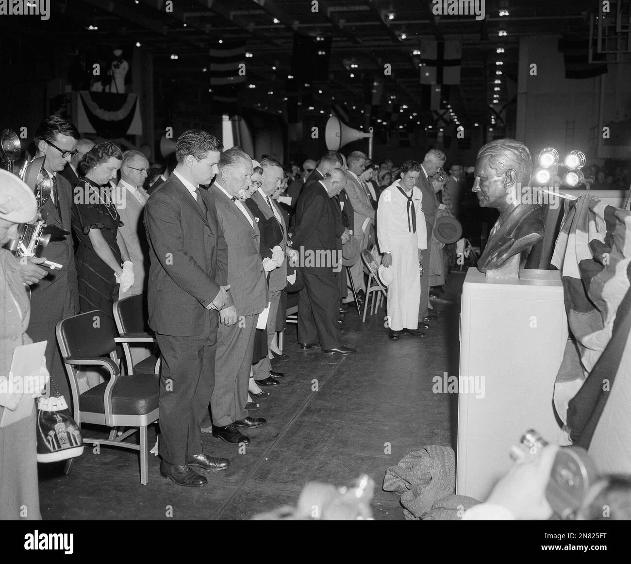 Michael Forrestal, left foreground, stands with bowed head during the closing prayer at ...