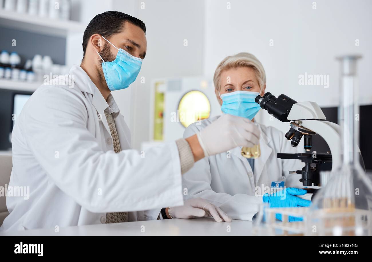Research, glass beaker and scientists working in laboratory for medical ...