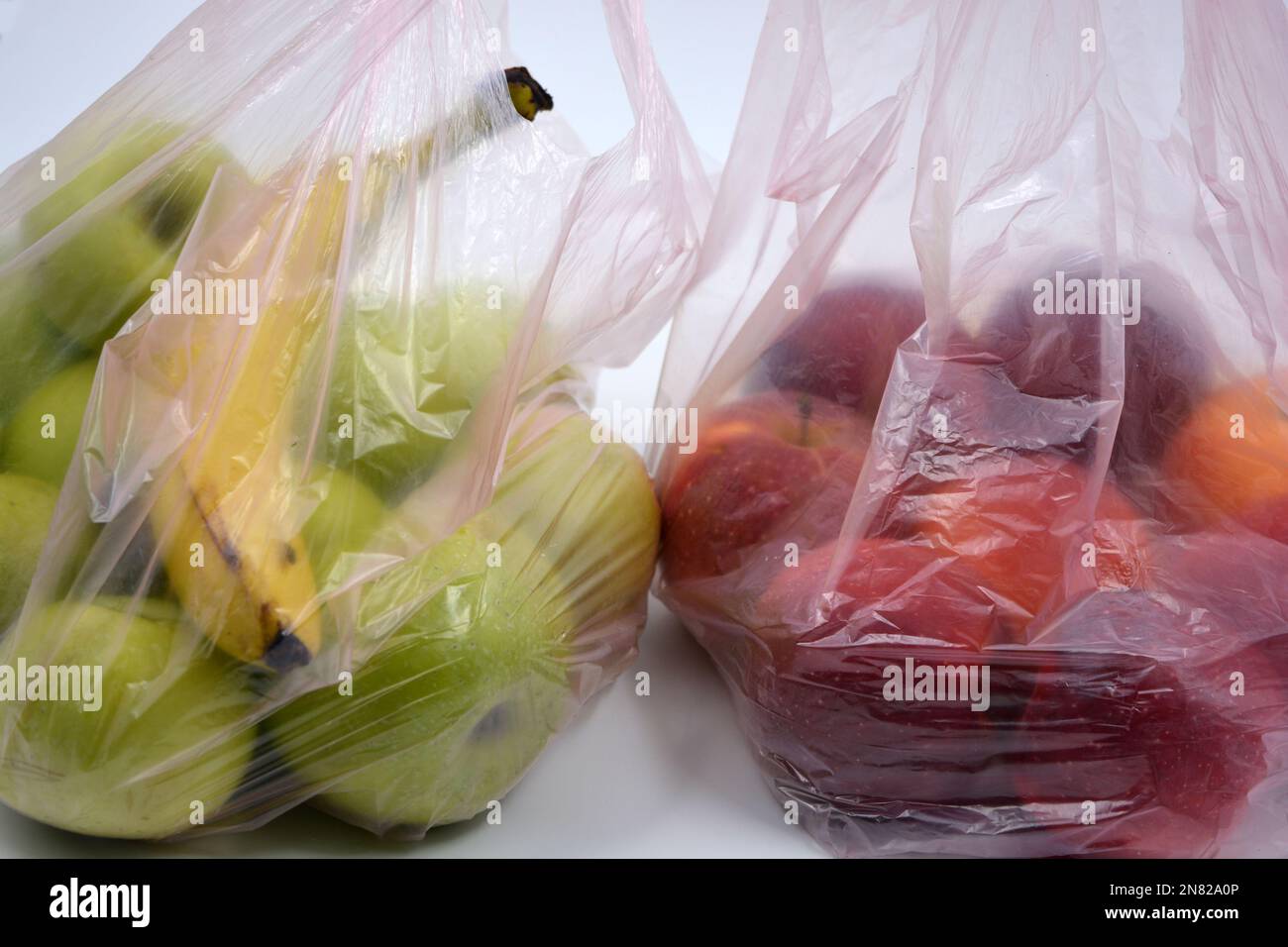 Two large packets of fruit, healthy food, many red, ripe apples and ...