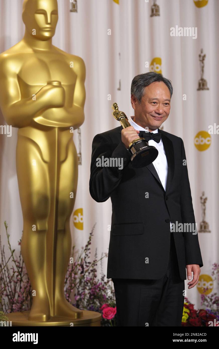 Ang Lee poses with his award for best directing for "Life of Pi" during ...