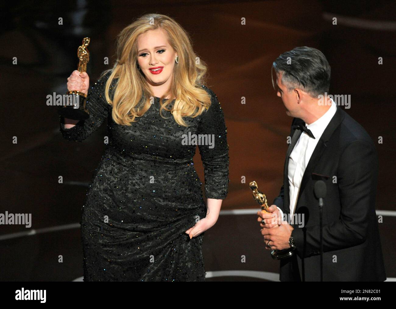 Singer Adele, left, and musician/producer Paul Epworth accept the award ...