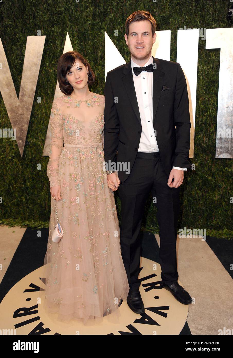 From left, actress Zooey Deschanel and writer Jamie Linden arrive at ...