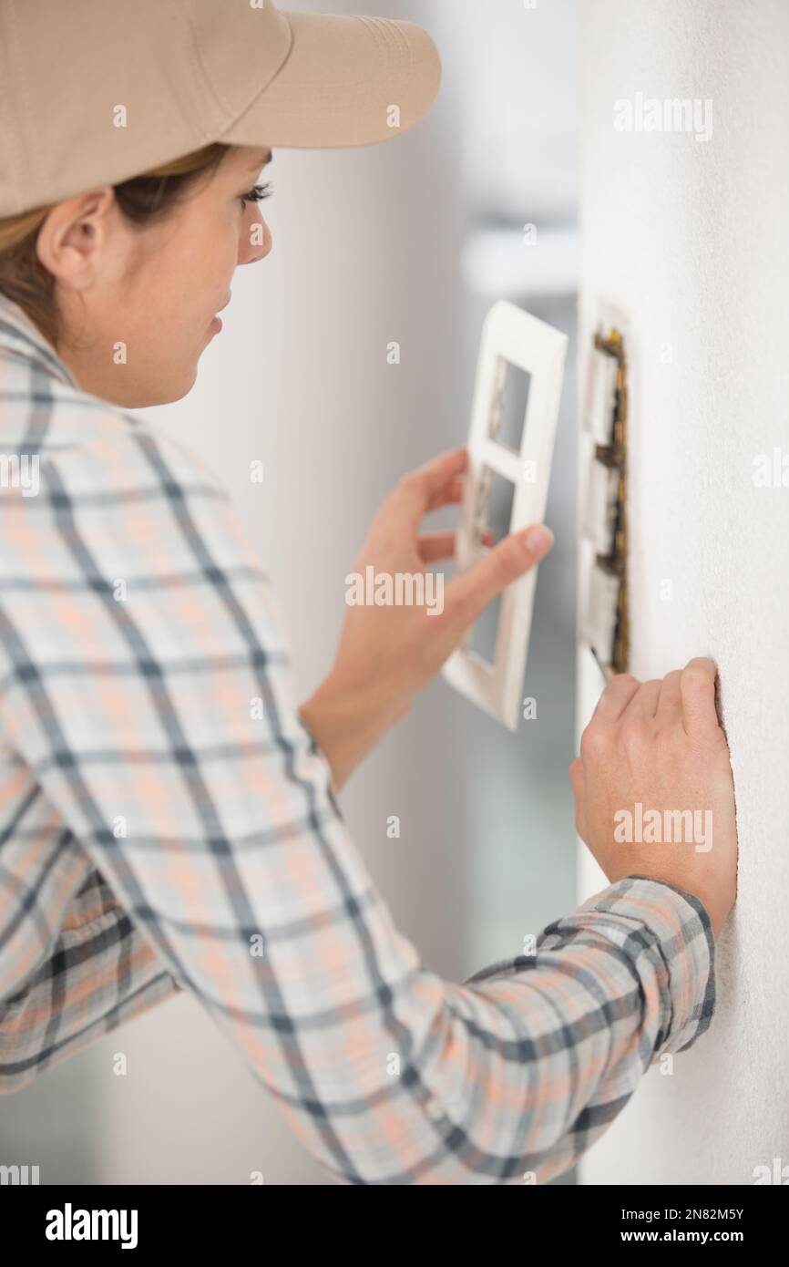 woman repairing a broken electrical outlet Stock Photo - Alamy
