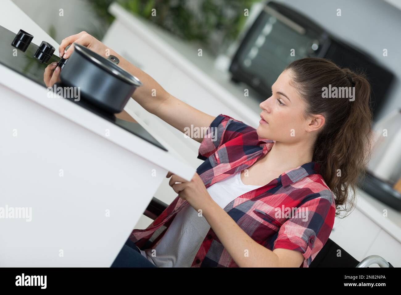 disabled woman cooking in her kitchen Stock Photo - Alamy