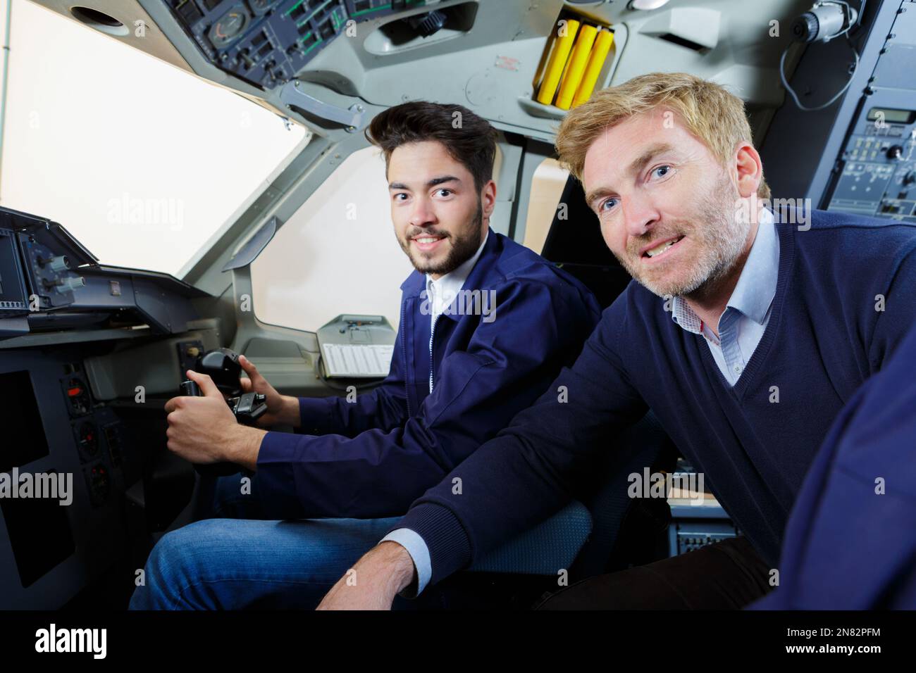 portrait of two pilots flying jet airliner Stock Photo - Alamy