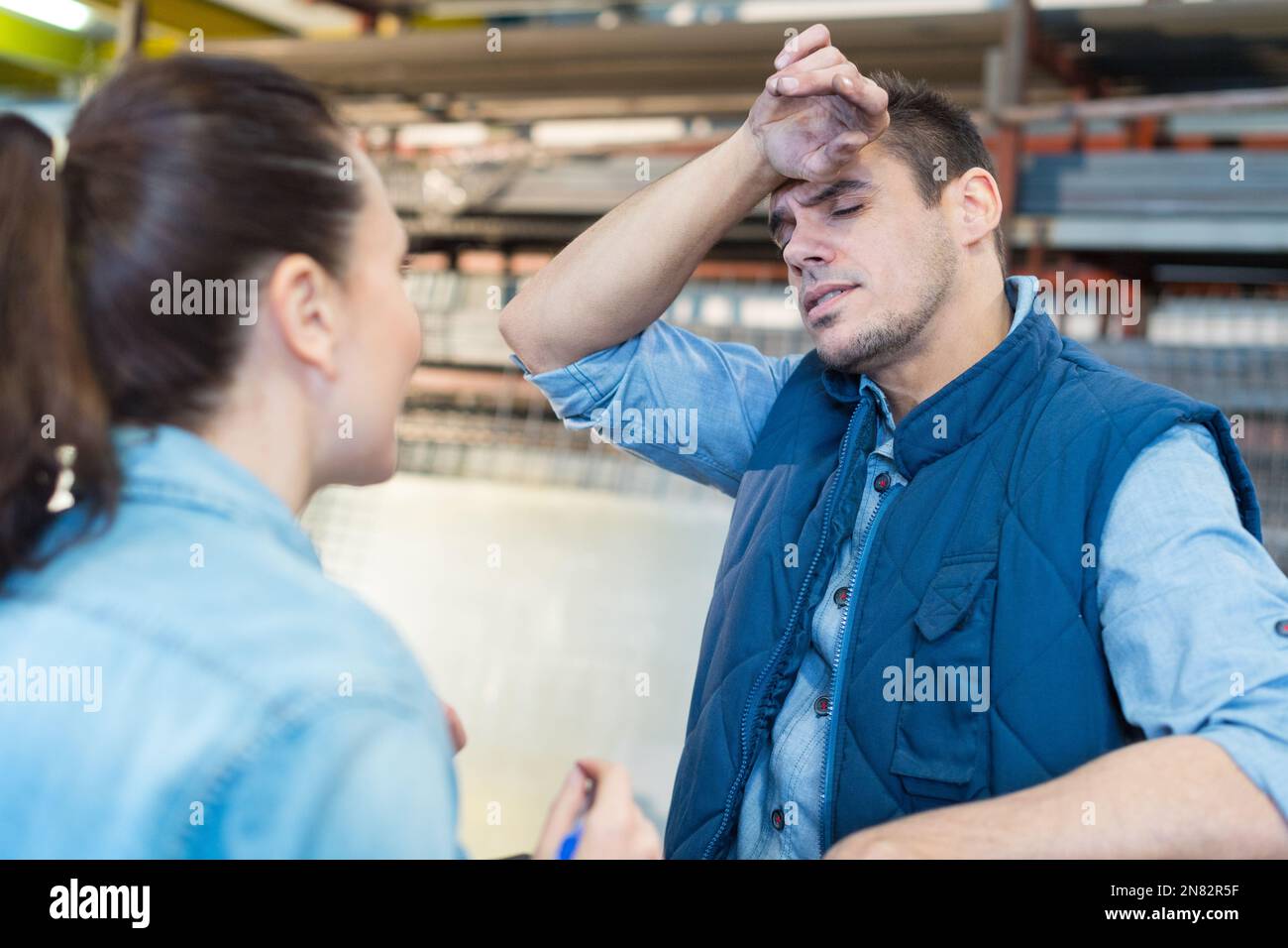 portrait of two tired workers at warehouse Stock Photo - Alamy