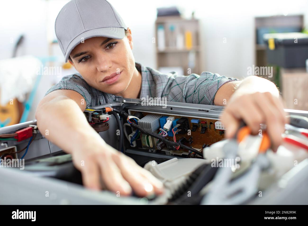 Cheerful young woman checking car hi-res stock photography and images ...