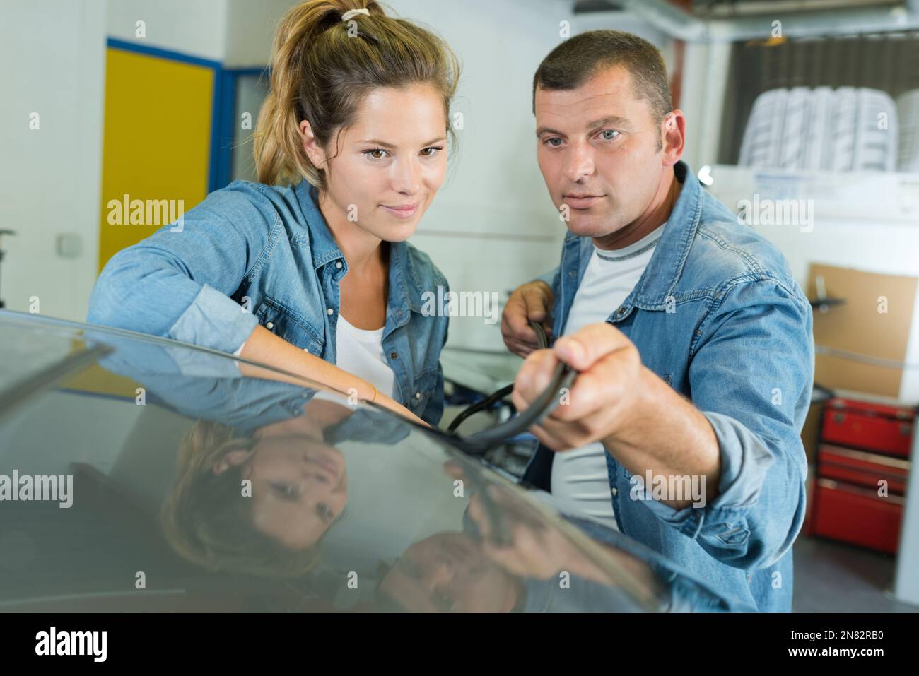 man inspecting the cars wipers Stock Photo - Alamy