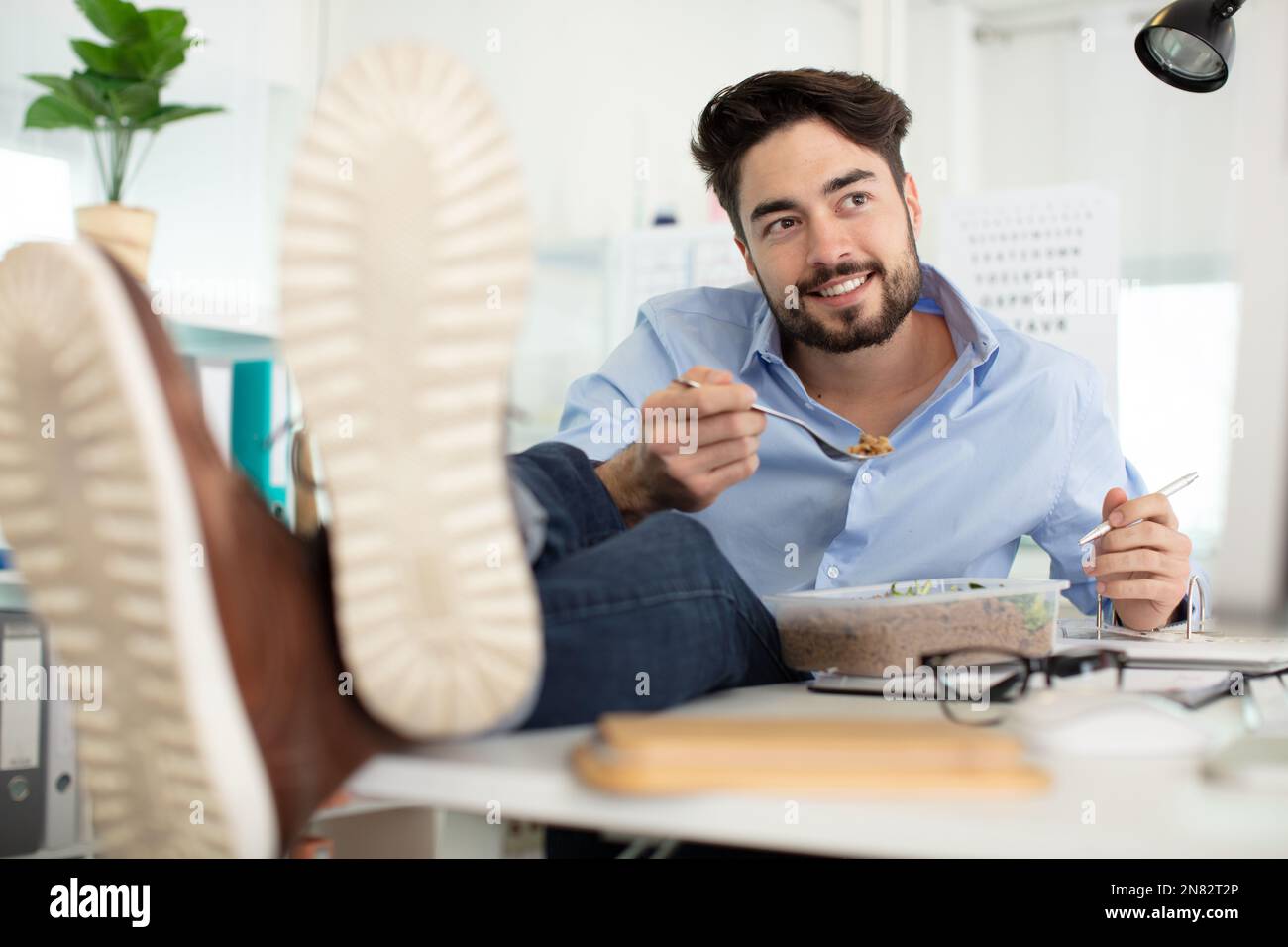 architect designing with computer feet up on desk Stock Photo - Alamy
