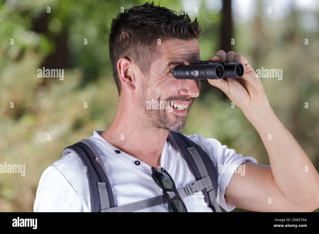 a man with binoculars walk in nature Stock Photo - Alamy