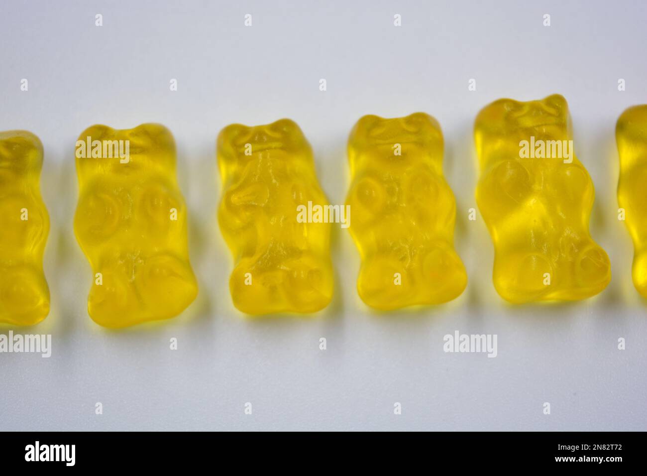 Bright children's yellow, orange chewing, jelly candies in the form and ...