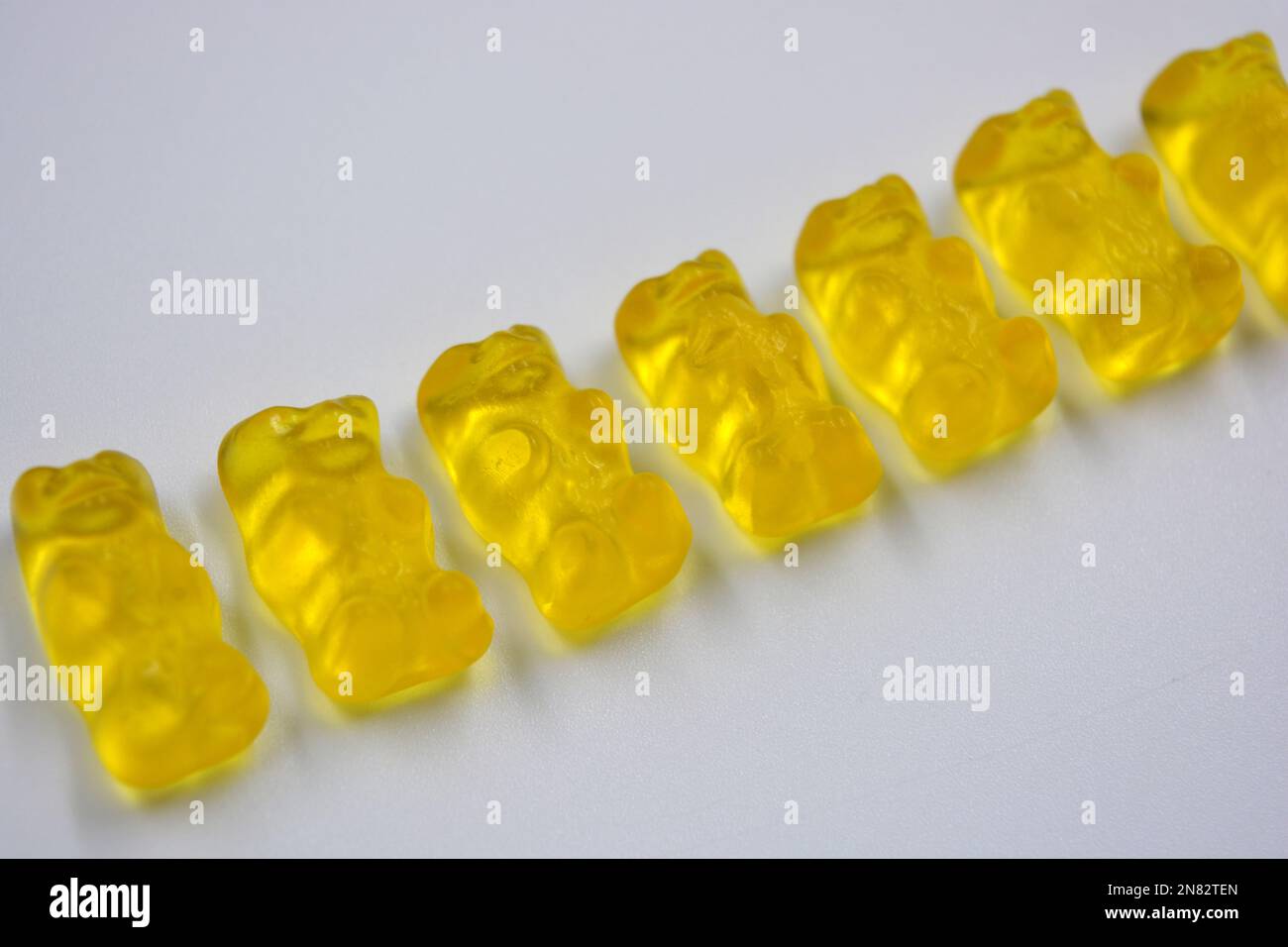 Bright children's yellow, orange chewing, jelly candies in the form and ...