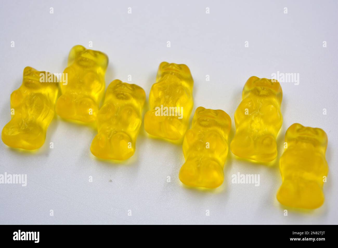 Bright children's yellow, orange chewing, jelly candies in the form and ...