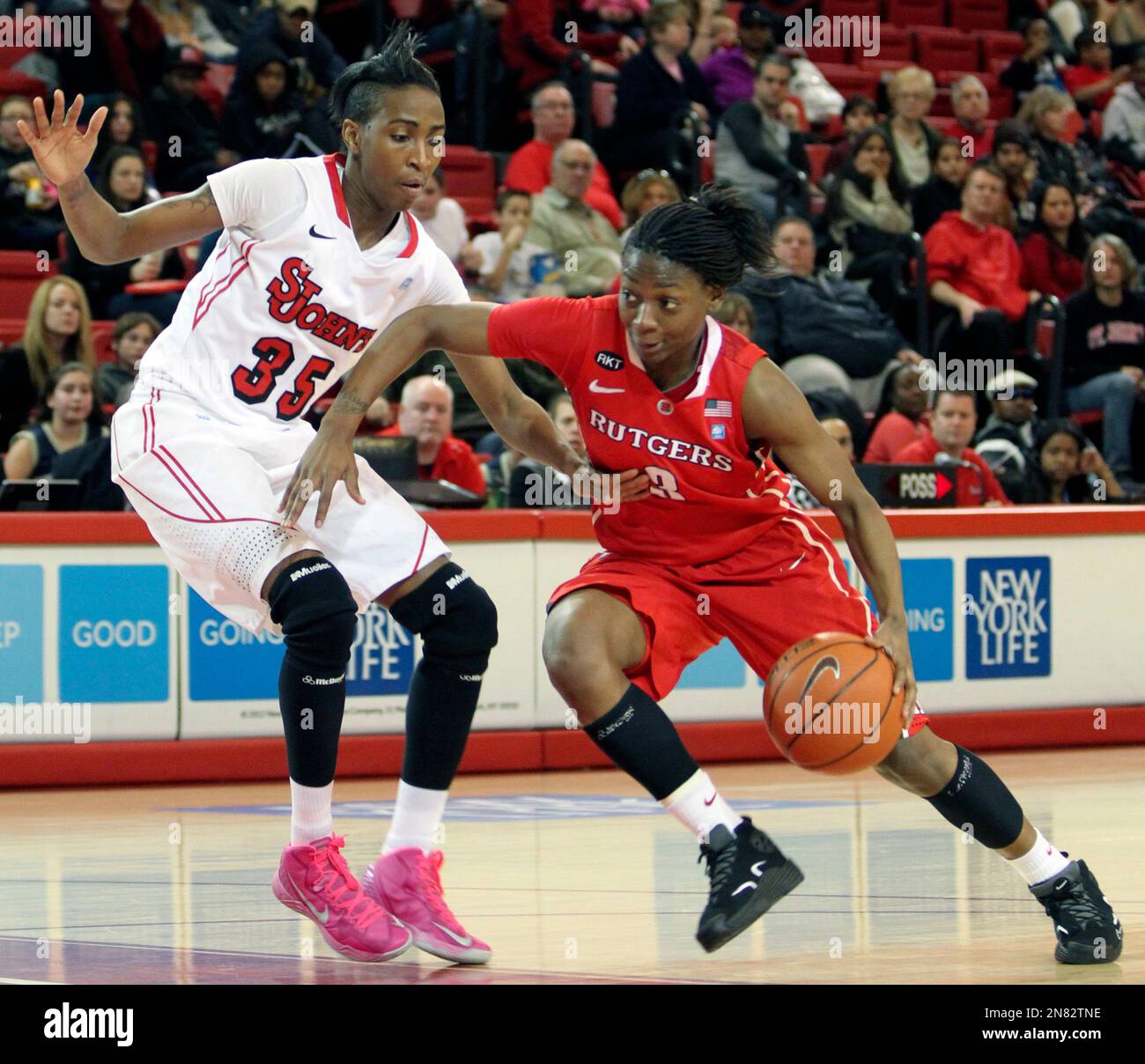 Rutgers' Erica Wheeler drives past St. John's Shenneika Smith (35 ...