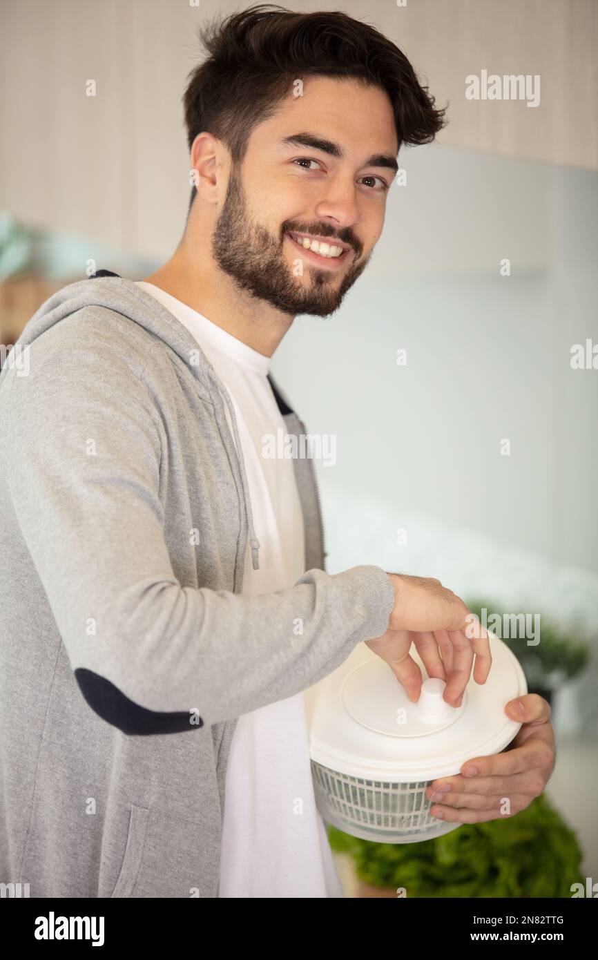 man using a sieve under running water Stock Photo - Alamy