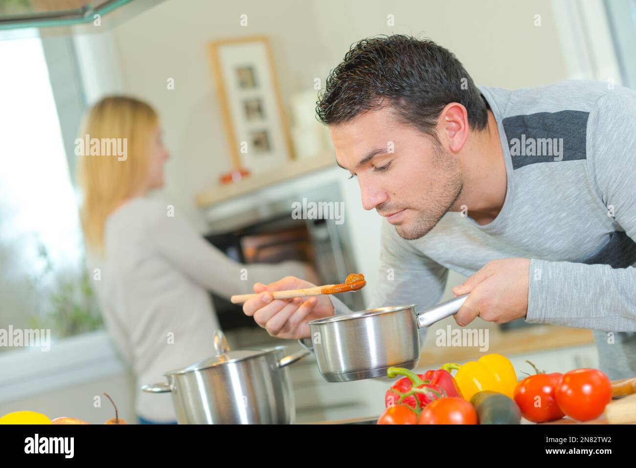 Testing food with spoon hi-res stock photography and images - Alamy