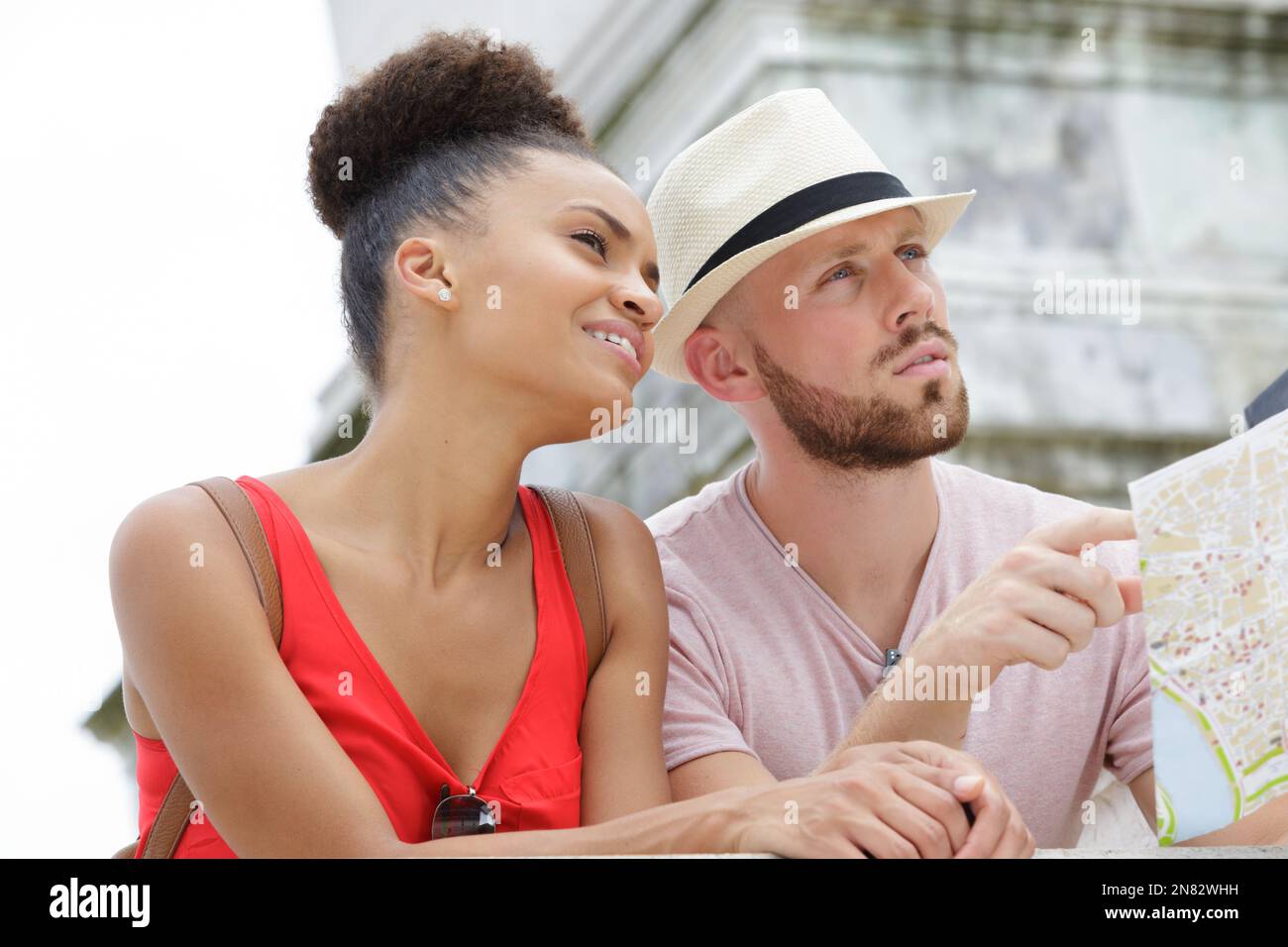 a couple is checking a map Stock Photo - Alamy