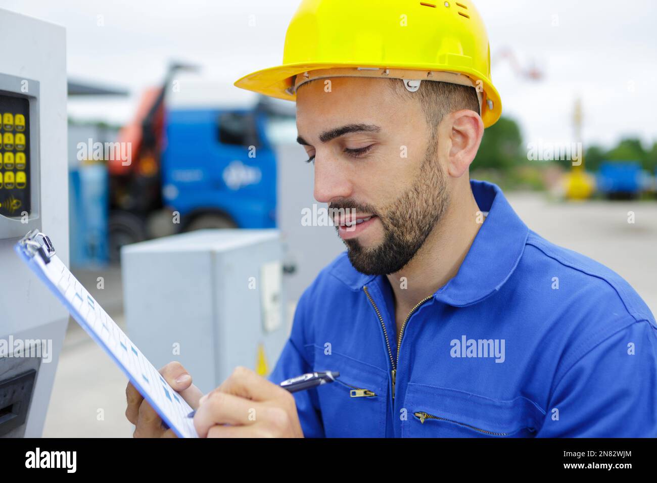 electrical engineer writing on clipboard Stock Photo - Alamy
