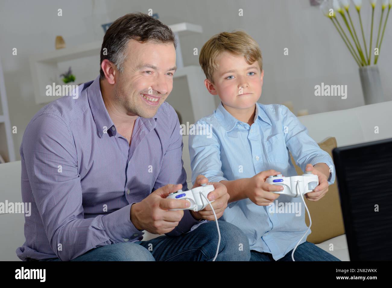 dad with his son playing video games Stock Photo - Alamy
