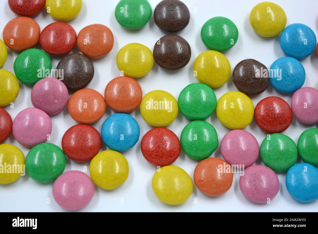 Bright and colorful, multi-colored chocolate candies covered with red ...