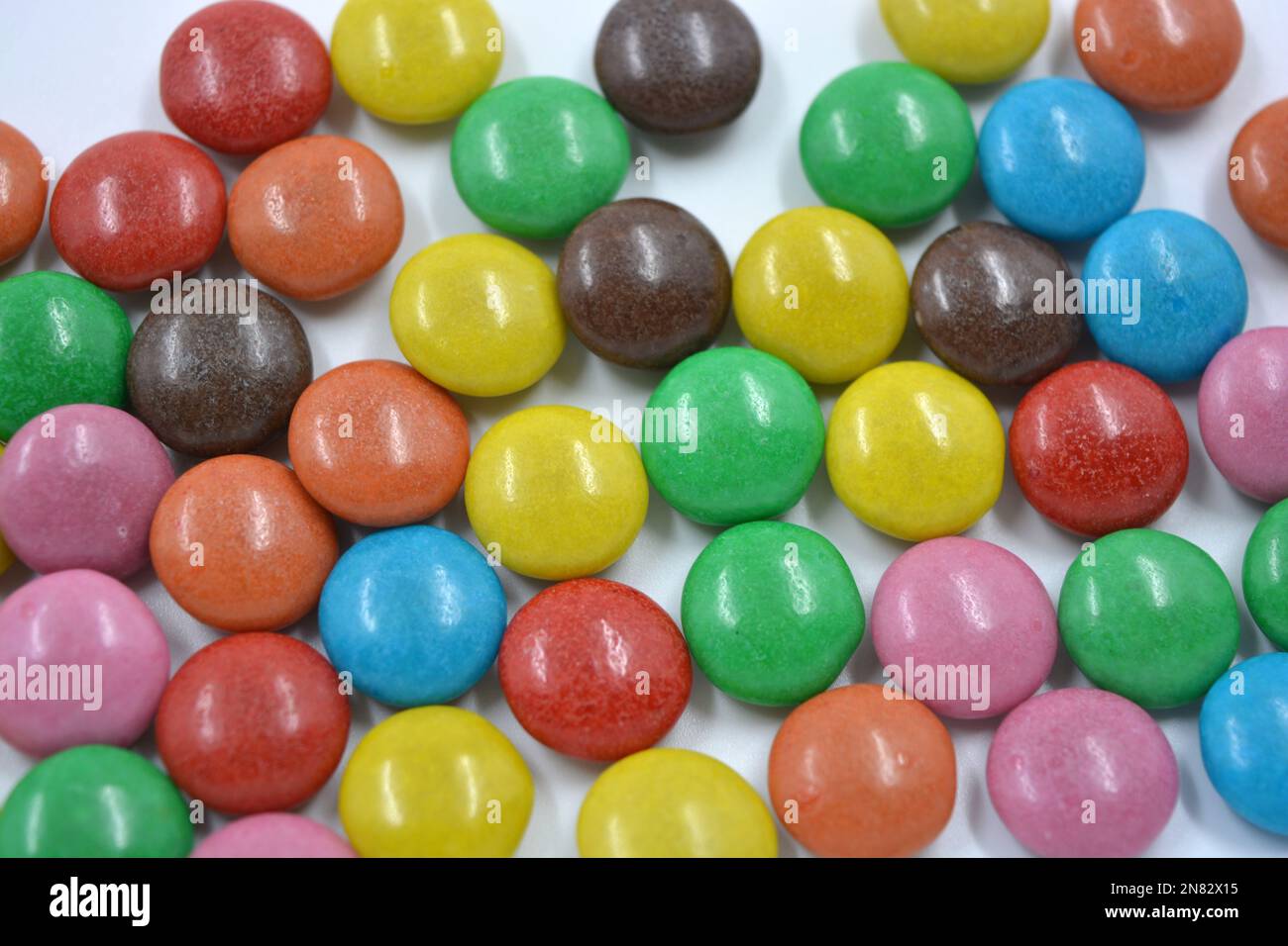 Bright and colorful, multi-colored chocolate candies covered with red ...