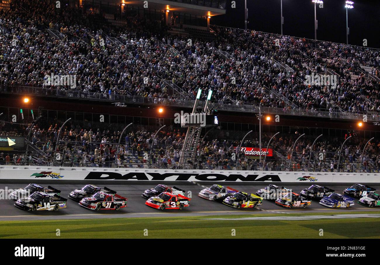 Pole-sitter Brennan Newberry (14) leads a group of trucks past the ...