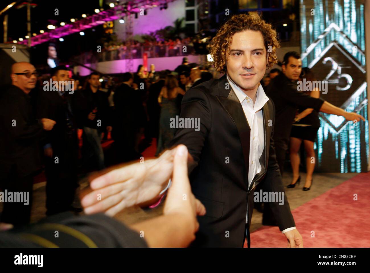 Spanish pop singer David Bisbal shakes the hand of a photographer as he ...