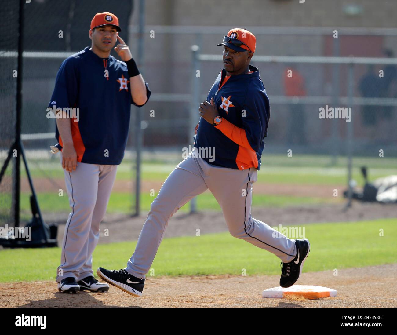 Houston Astros manager Bo Porter, right, rounds third base as he shows ...