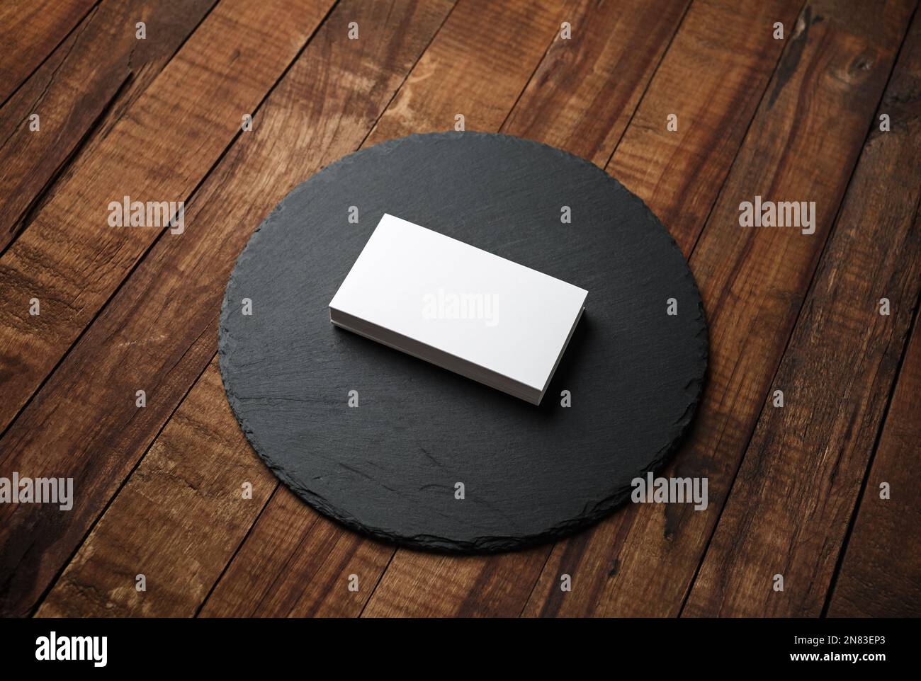 Blank business card and round slate plate. Mock-up for branding ...