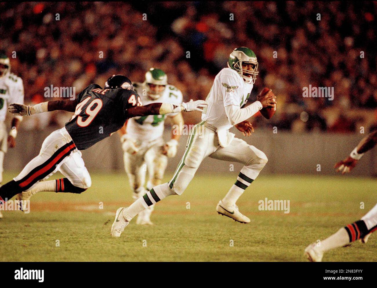 Philadelphia Eagles quarterback Randal Cunningham (12) scrambles out of ...