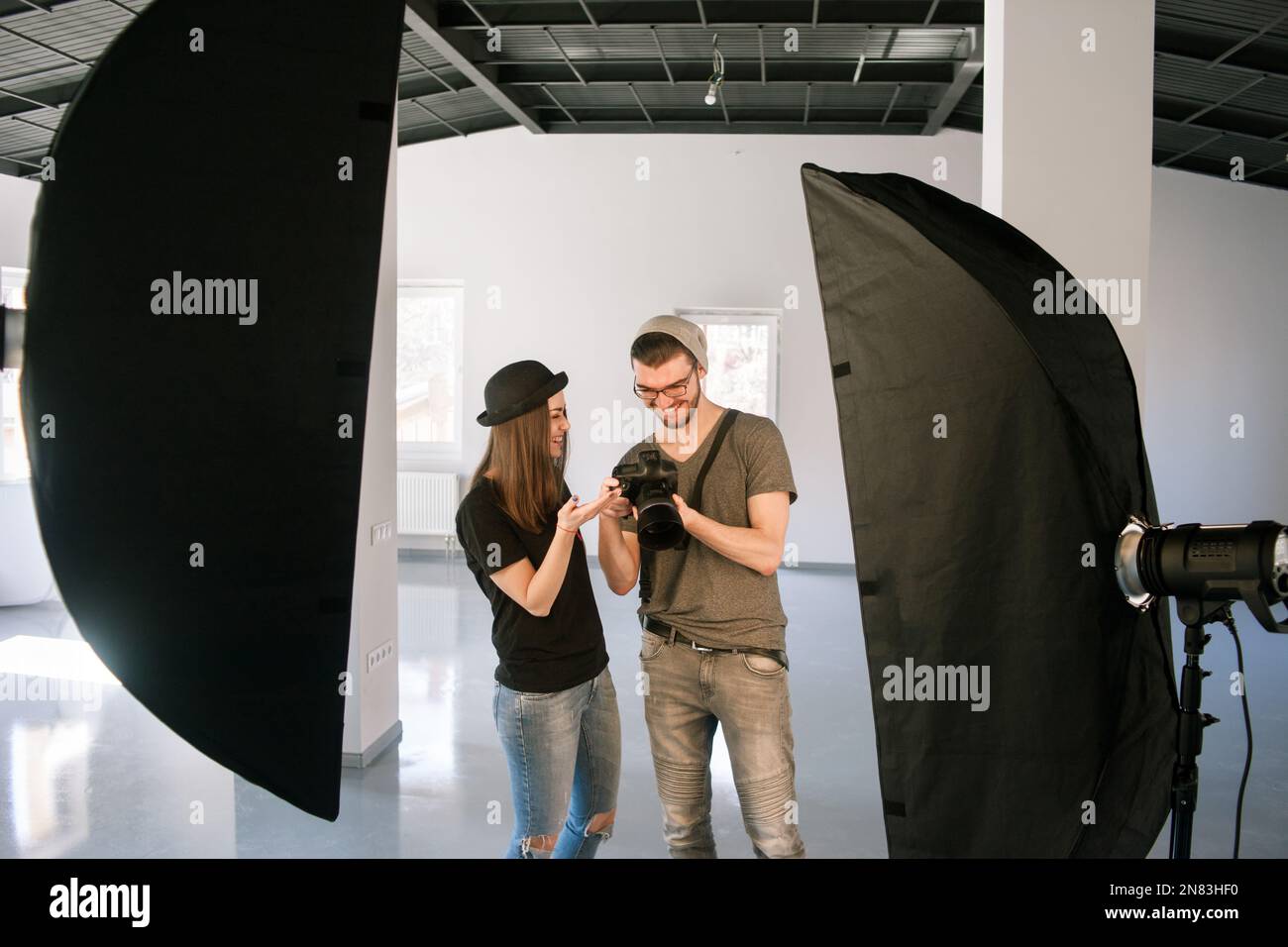 Model and photographer enjoy photos on camera Stock Photo - Alamy