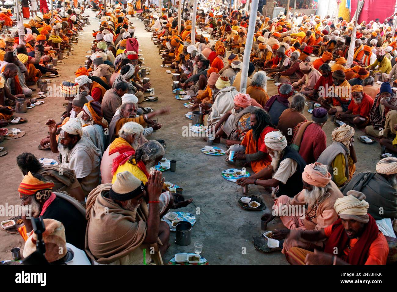 Indian Hindu holy men eat during a community feast at the Ashram of ...
