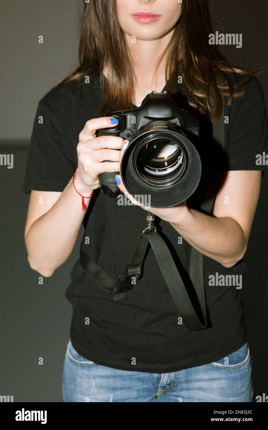 Female photographer and camera with big lens Stock Photo - Alamy