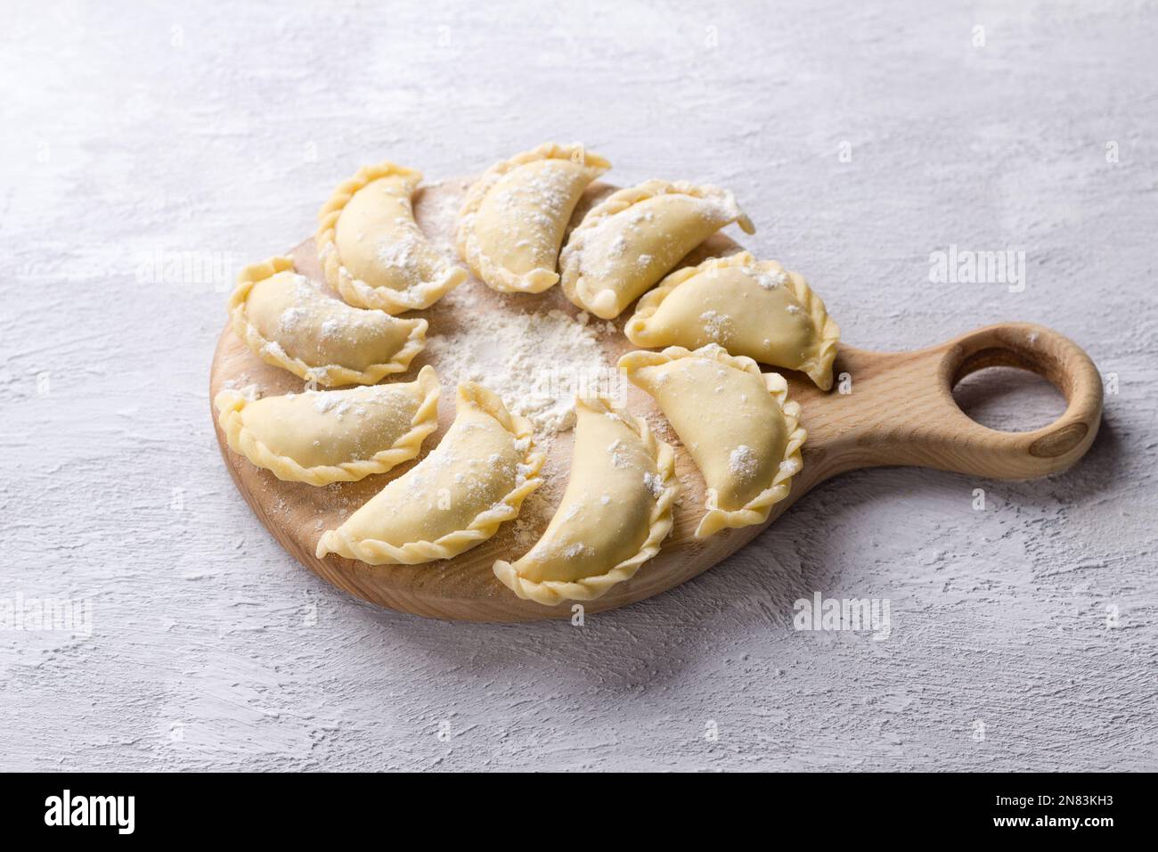 Homemade raw frozen vegan dumplings, vareniki, pierogi, kreplach ...