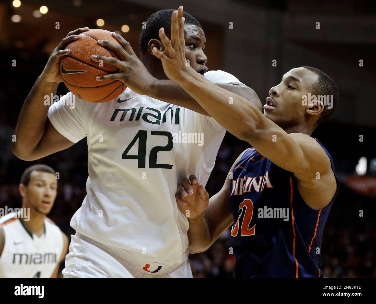 Virginia's Darion Atkins (32) blocks Miami's Reggie Johnson (42) during the first half of an ...