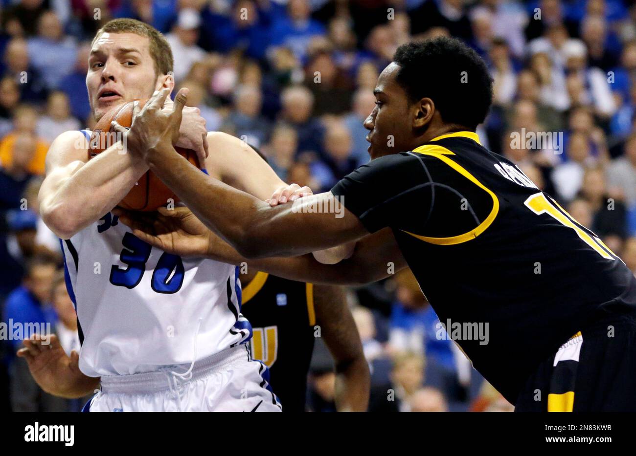 Saint Louis' Jake Barnett, left, tries to hold onto the ball as ...