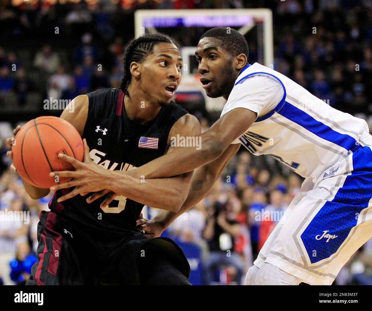 Southern Illinois' Desmar Jackson, left, is defended by Creighton's ...