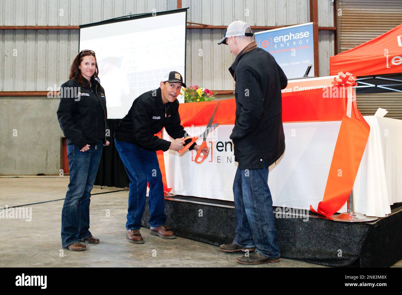 North State Solar Energy President Mike Houar, center, cuts the ribbon ...