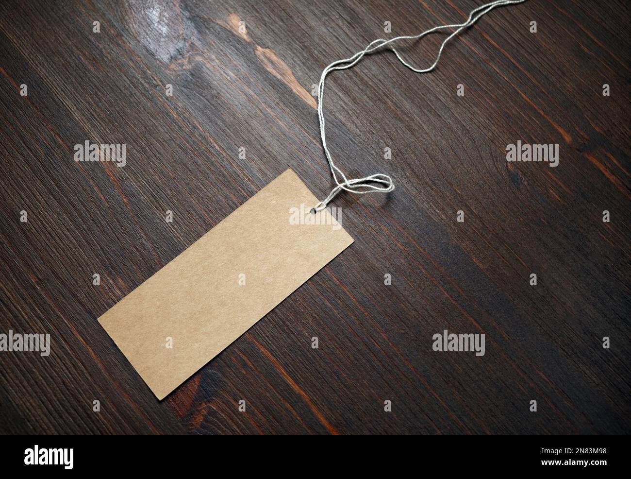 Blank cardboard tag label on wooden background. Template for your ...